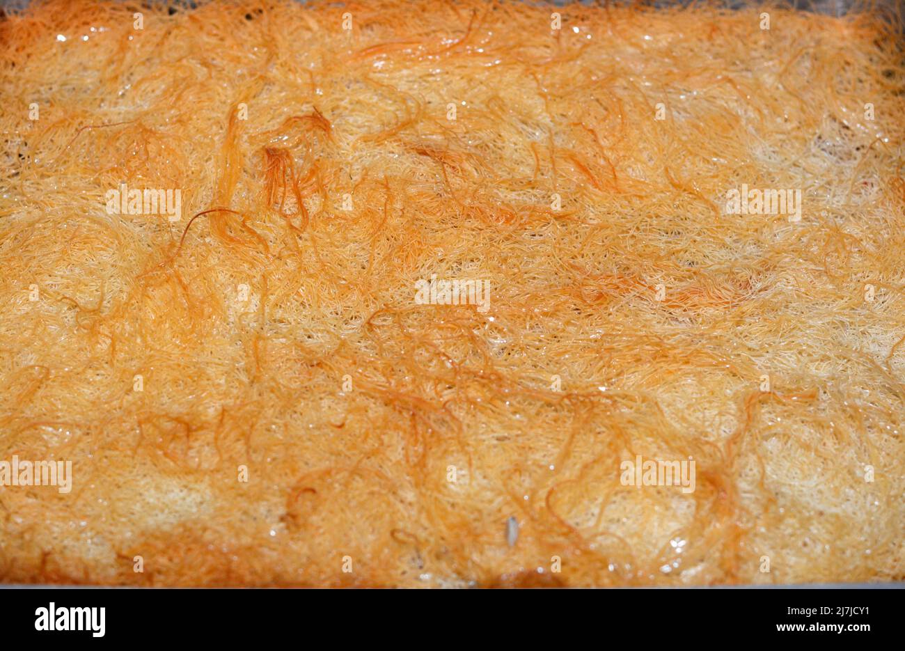 A traditional middle eastern dessert Knafeh made with spun pastry ...