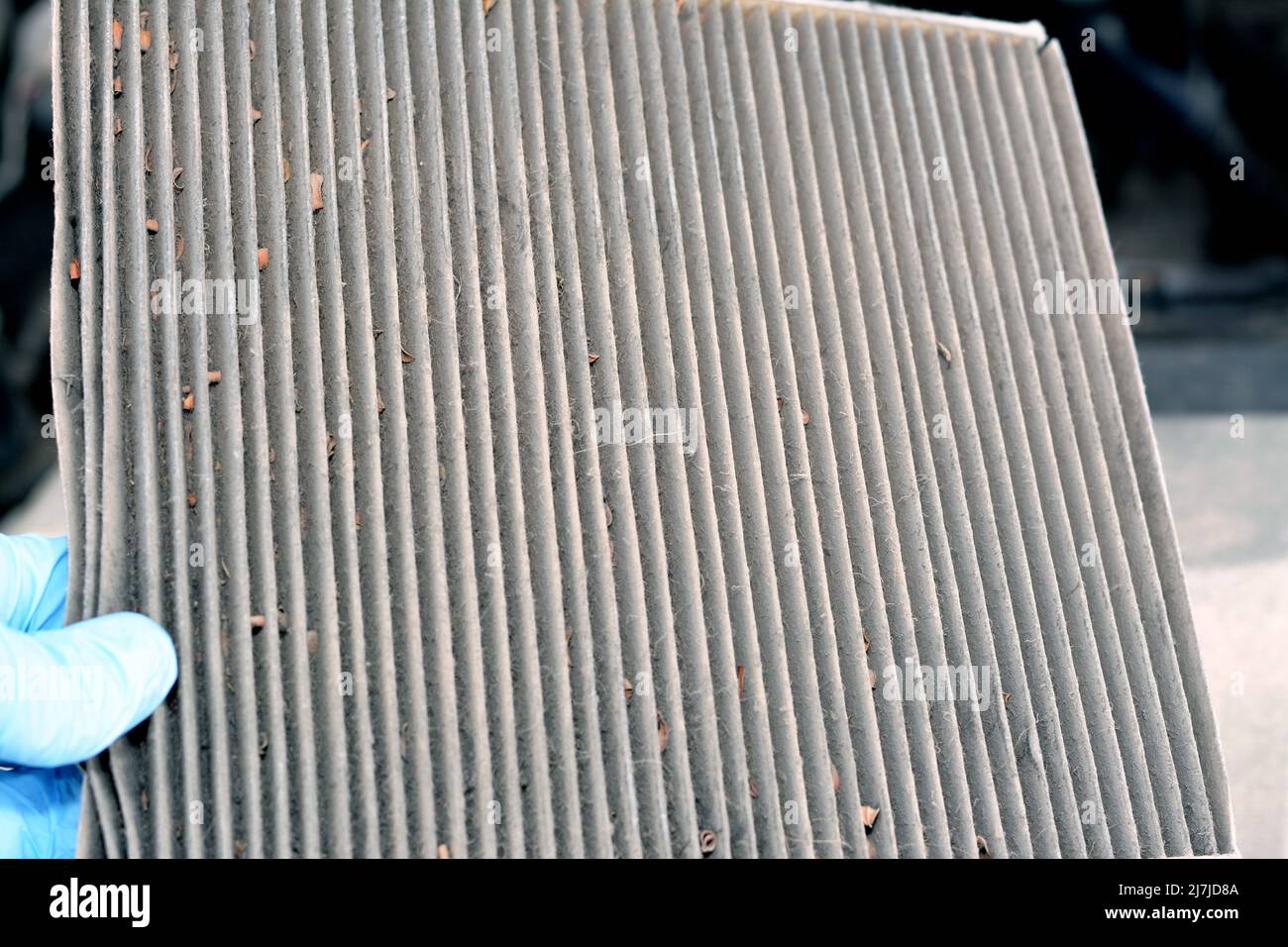 A closeup of an old dirty used car AC air conditioning filter full of ...