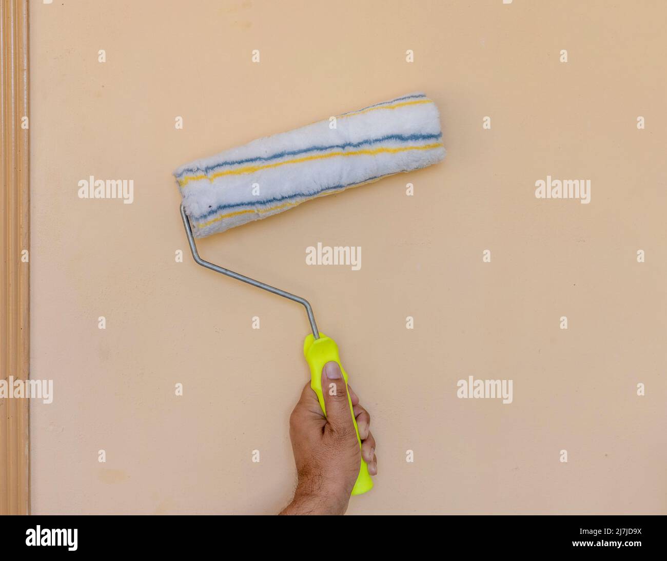 Hand holding roll painter hi-res stock photography and images - Alamy