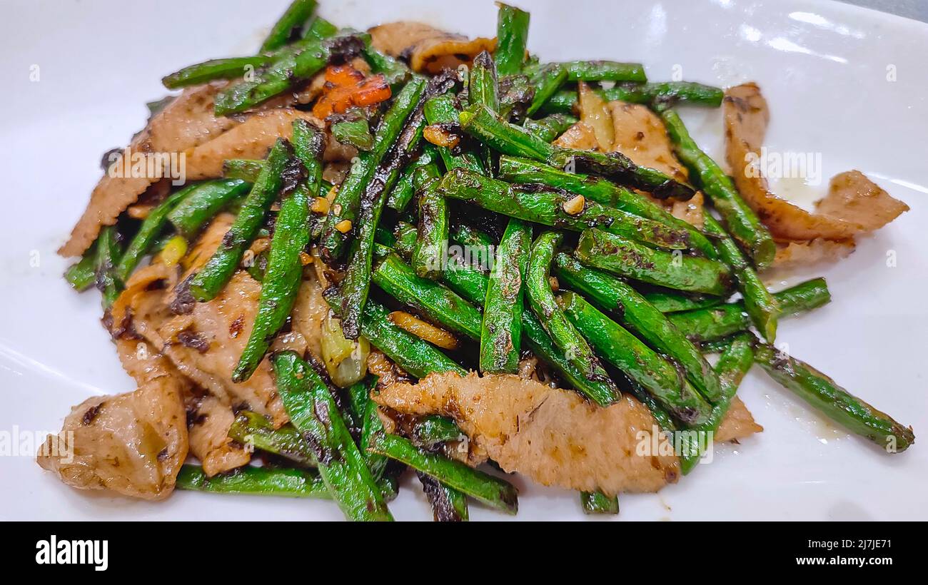 Fried green string bean with pork on white plate, Thai food Stock Photo ...
