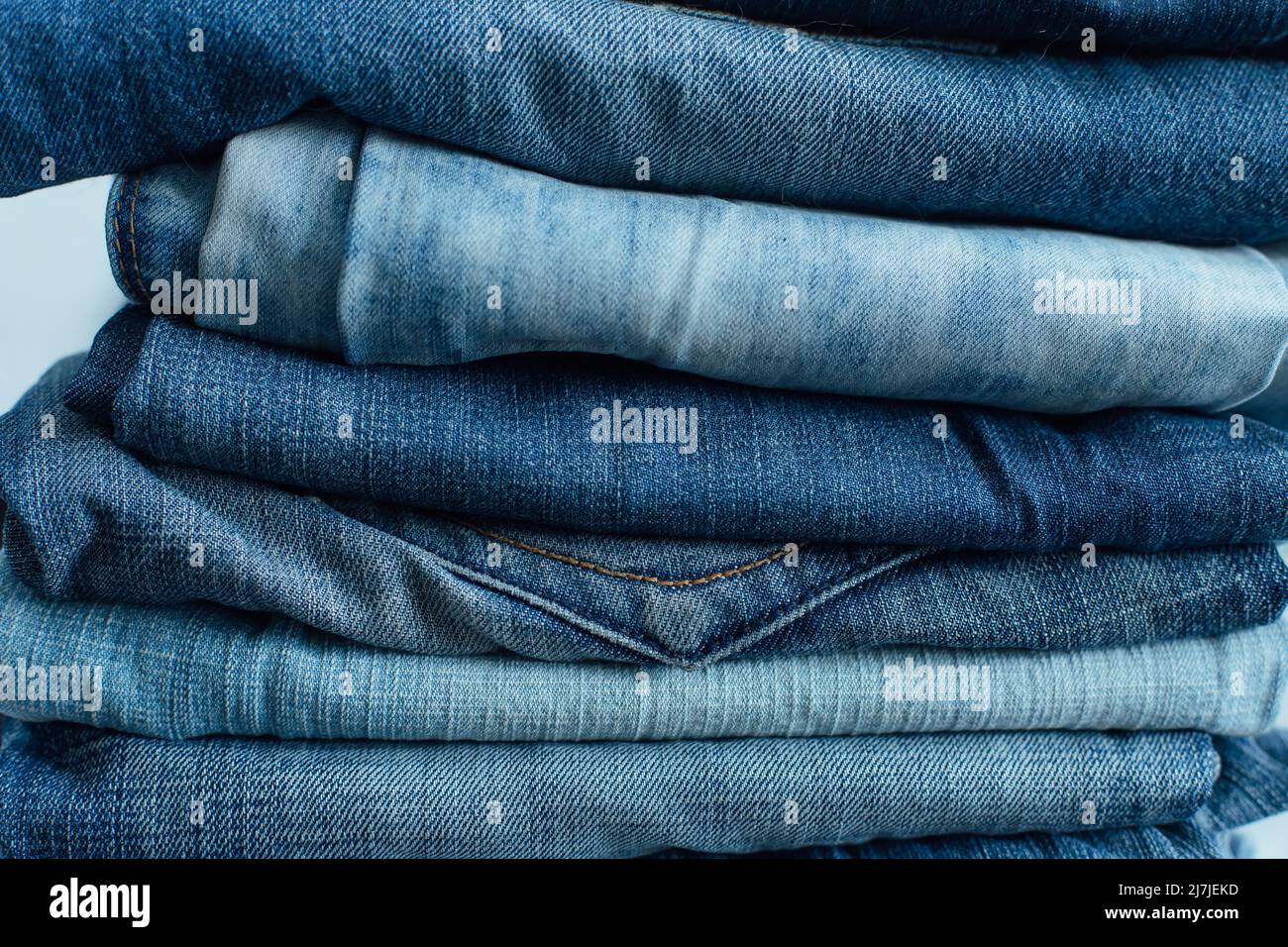 Stack of a stack of old jeans various shades of blue jeans. Denim jeans ...