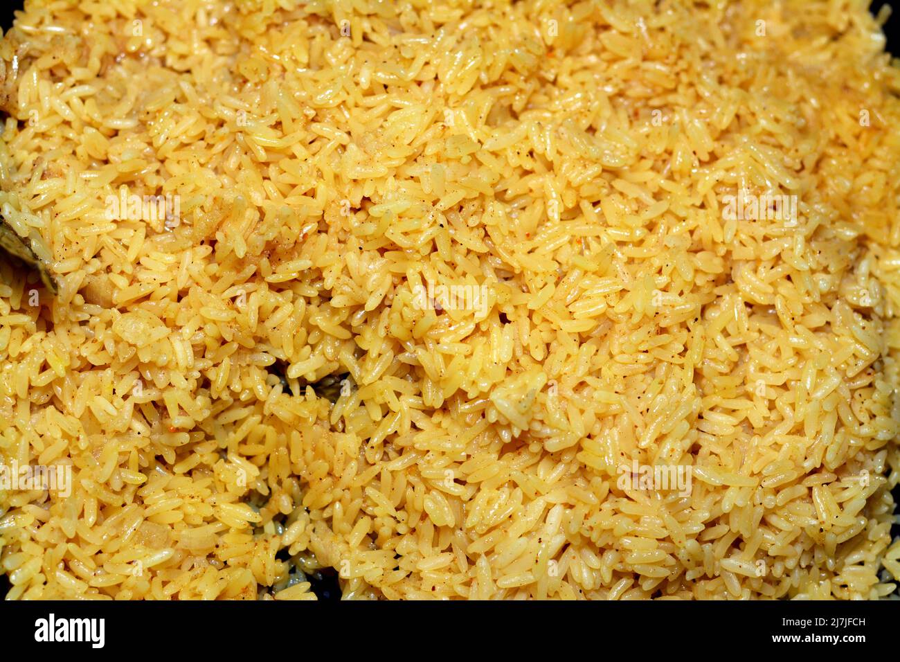 Selective focus of long grain yellow Basmati rice cooked on hot steam ...