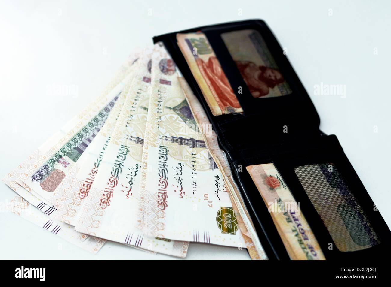 Egyptian money banknote inside a black wallet isolated on a black ...