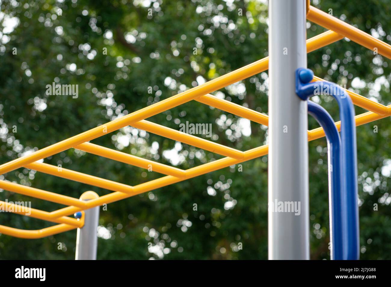 Yellow color monkey bars on a playground Stock Photo - Alamy
