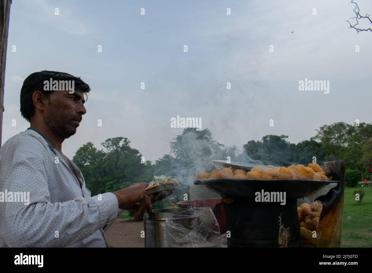 An Indian man is making street food outdoor Stock Photo - Alamy