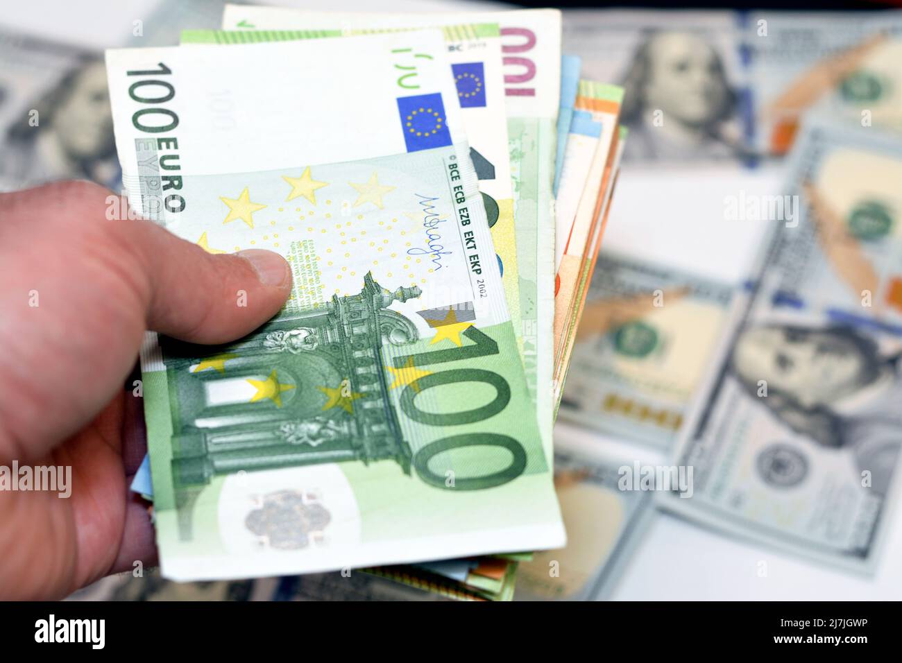 man hand holding a stack of 100 one hundred European euros banknotes ...