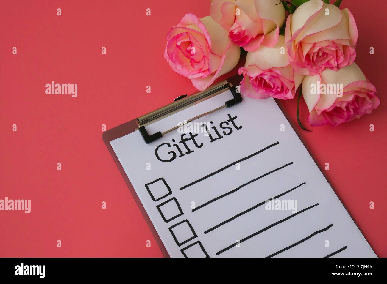 GIFT LIST on paper note. Delicate pink roses on pink background ...