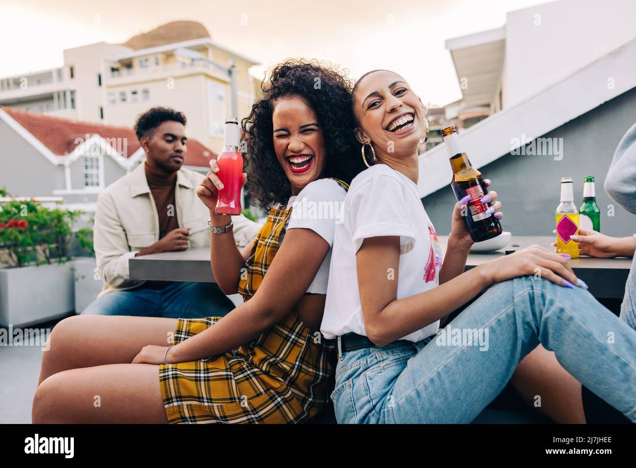 Best friends enjoying cold drinks on the weekend. Two happy young women ...