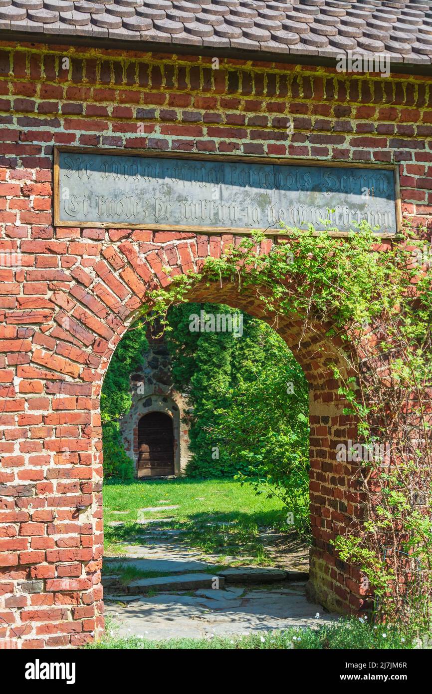 Red brick gate with a bronze palque to church in Lepaa Finland Stock ...