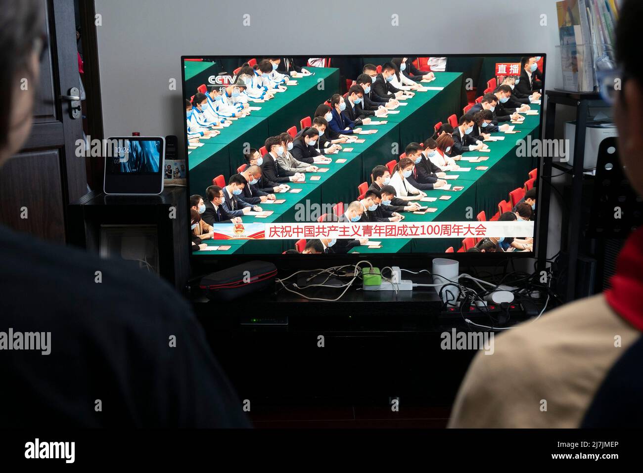 SHANGHAI, CHINA - MAY 10, 2022 - Two citizens watch a live TV broadcast ...