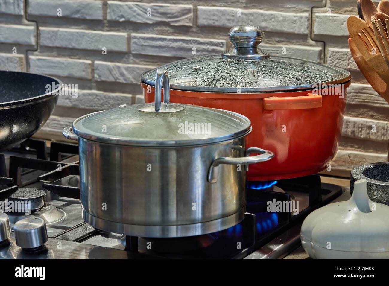 Pots with cooking food in the kitchen on gas stove Stock Photo - Alamy