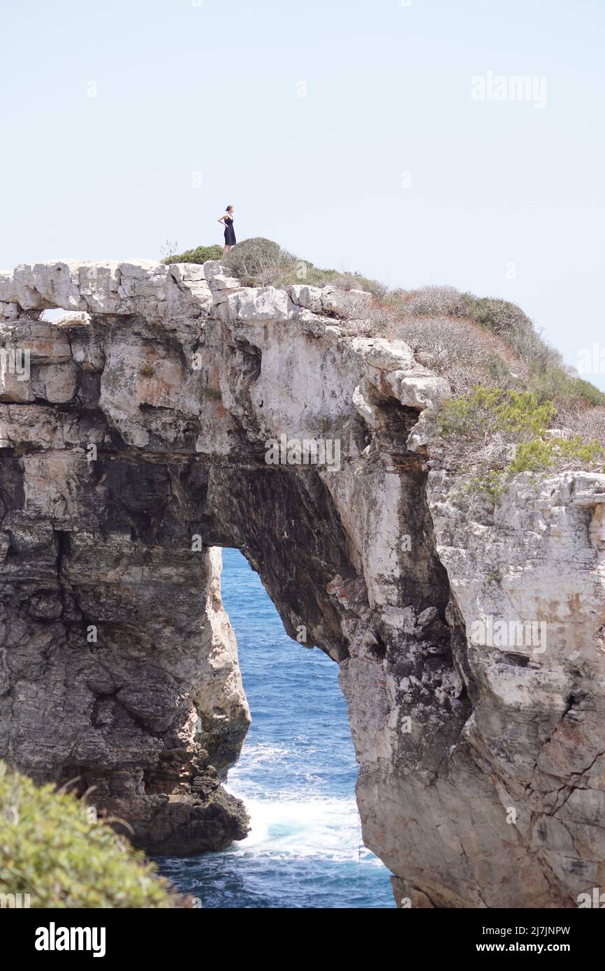 Woman on rock bridge Stock Photo - Alamy