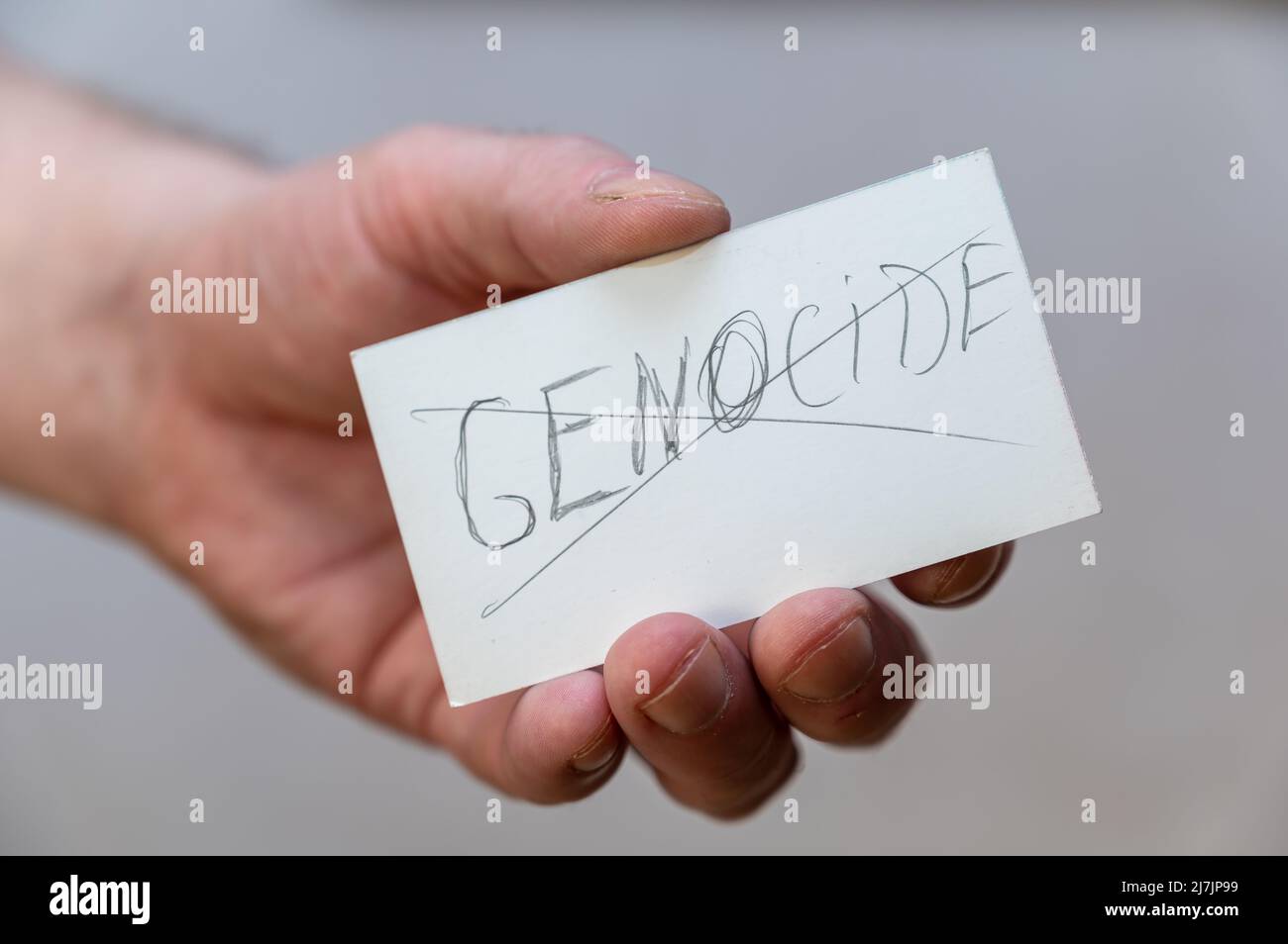 The word GENOCIDE is crossed out. A word written in jagged letters. A ...