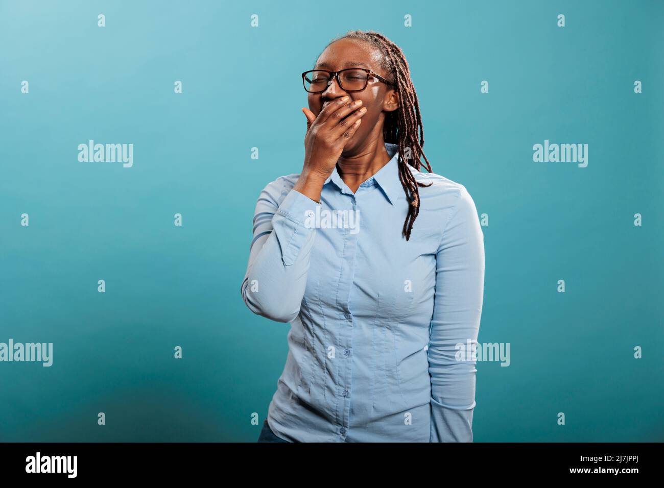 Tired sleepy young adult woman yawning mouth wide open because of ...