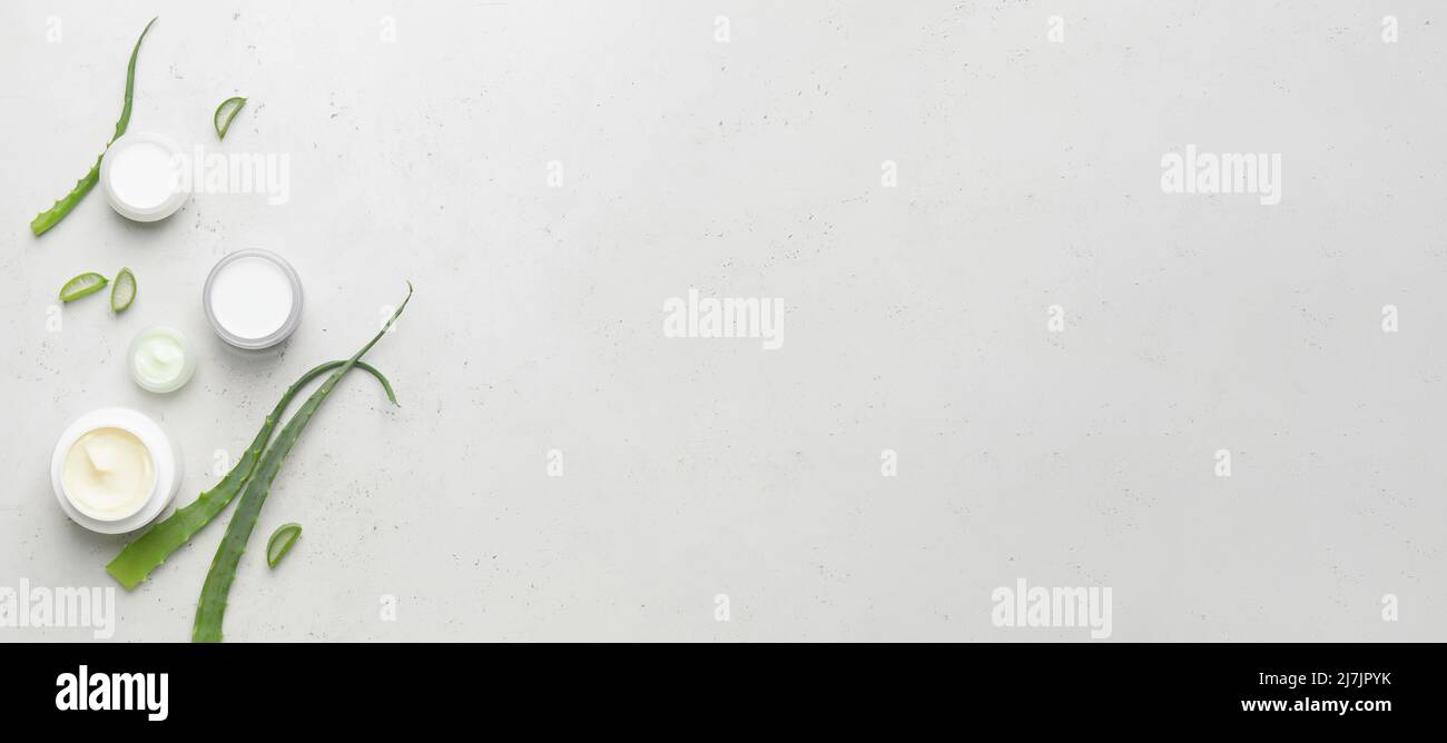 Cosmetic creams with aloe vera extract on light background with space ...