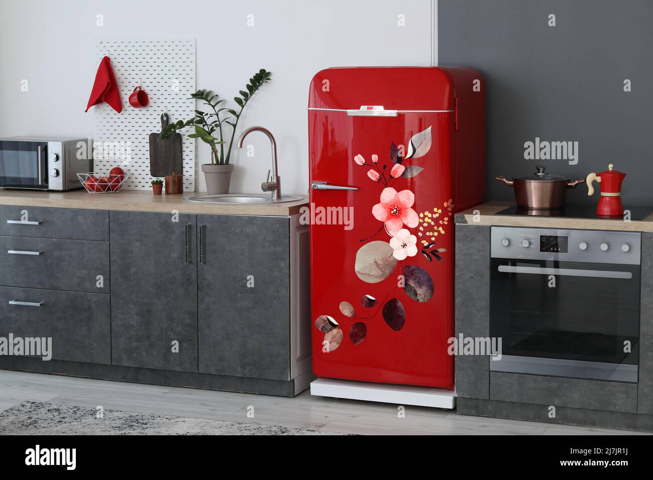 Red refrigerator with print of leaves and flowers in interior of modern ...