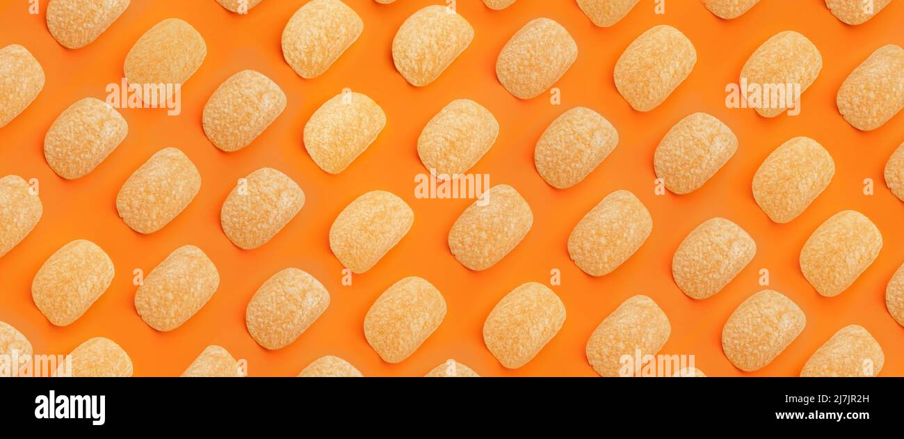 Tasty potato chips on orange background. Texture for design Stock Photo ...