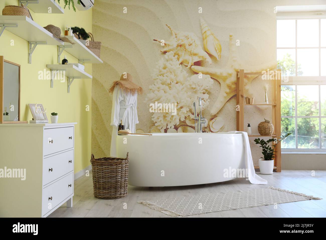 Interior of light bathroom with printed sea shells and coral on wall ...
