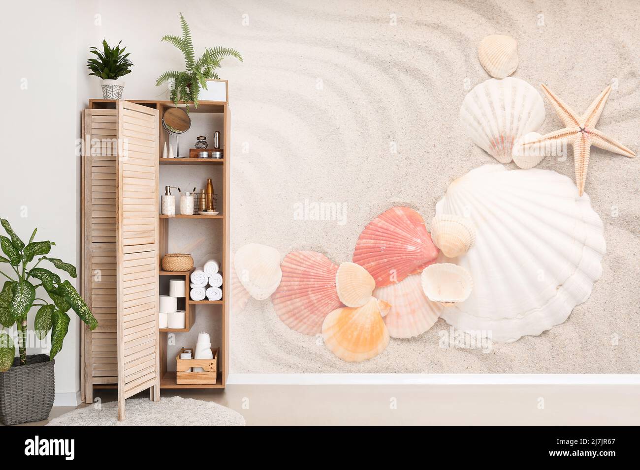 Shelf unit and folding screen near wall with print of sea shells in ...
