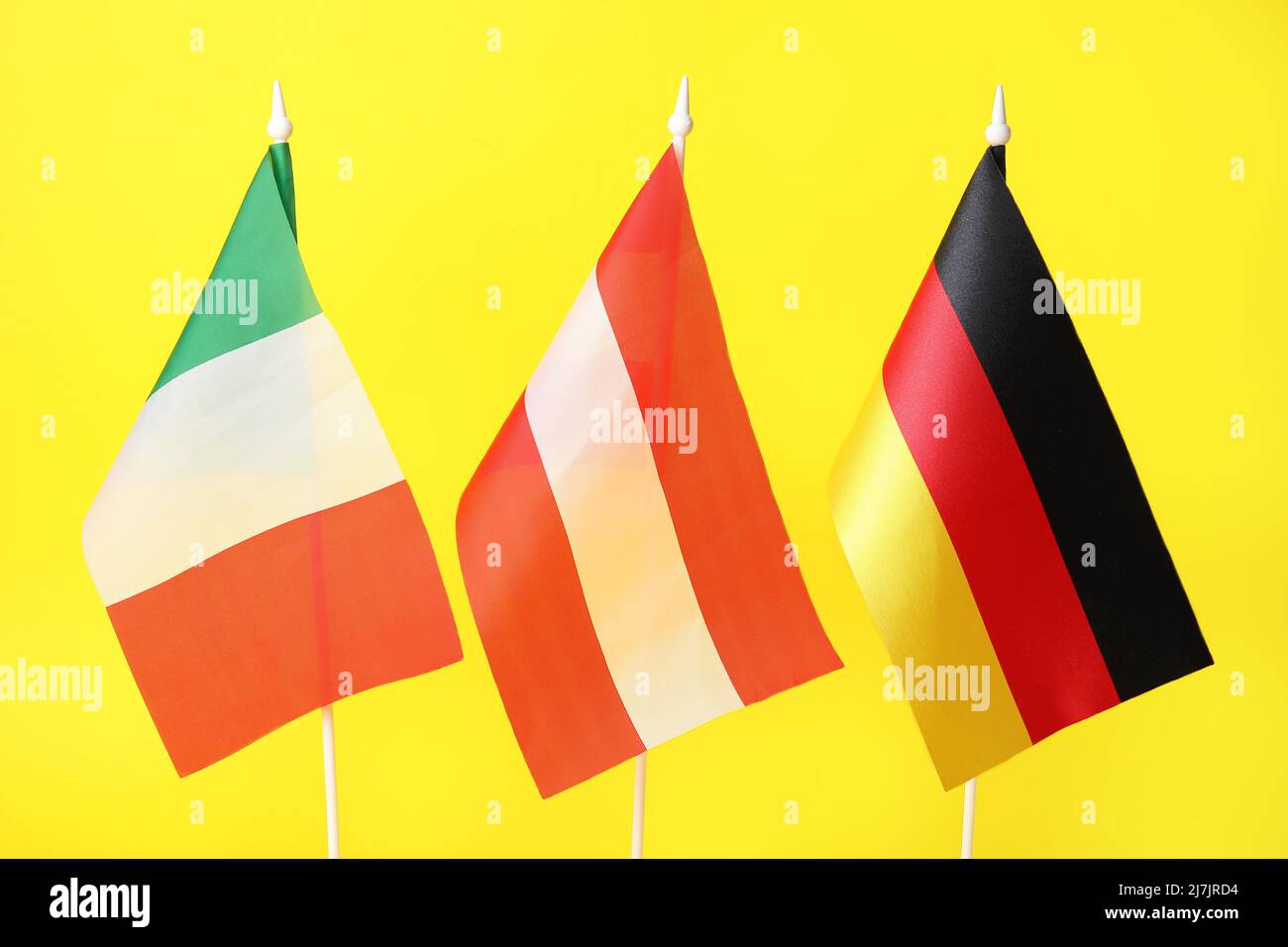 Flags of Italy, Austria and Germany on yellow background, closeup Stock ...