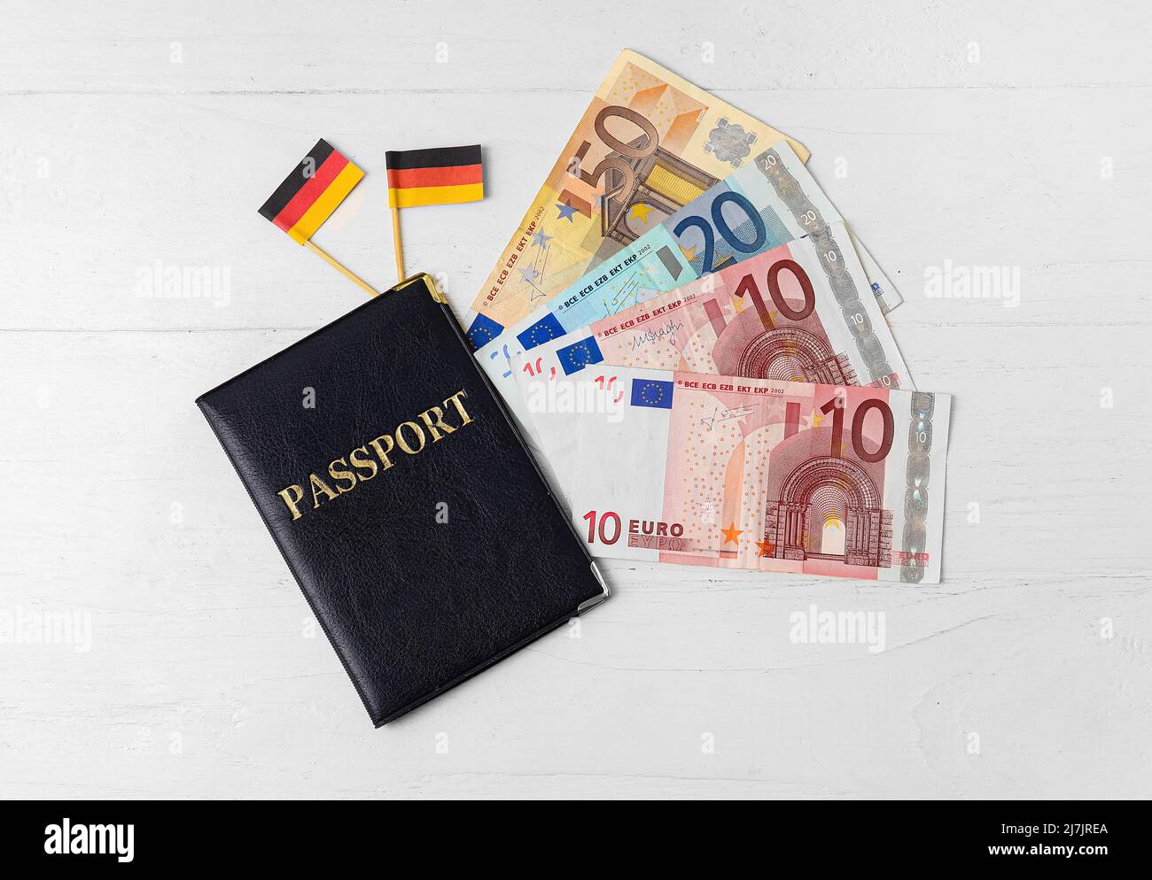 Passport, money and flags of Germany on white wooden background Stock ...