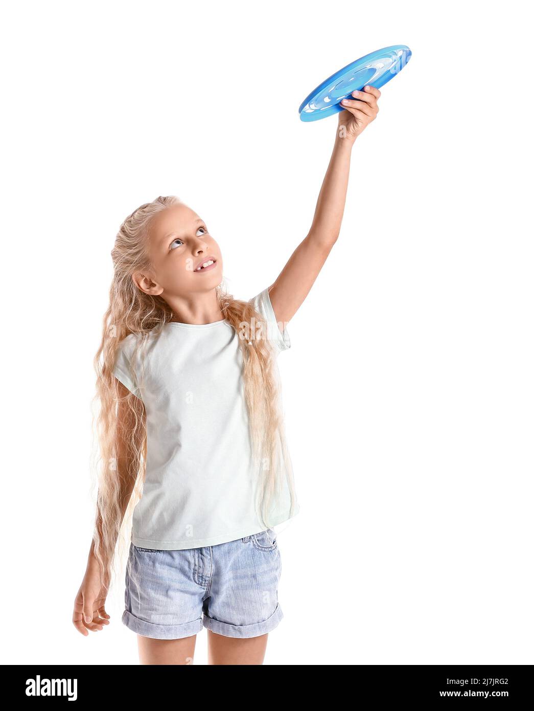 Funny little girl playing frisbee on white background Stock Photo - Alamy