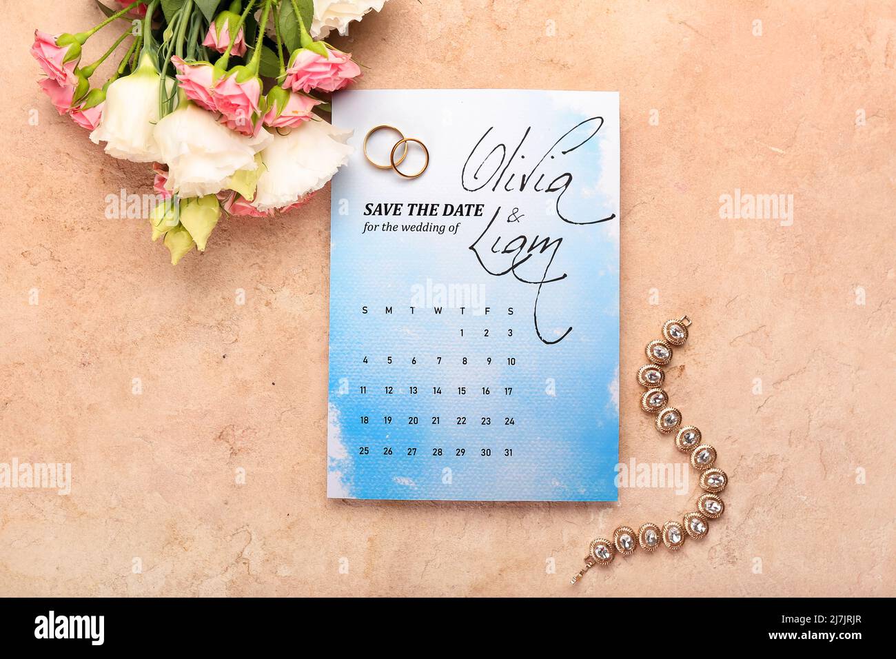 Wedding calendar and rings on color background Stock Photo - Alamy
