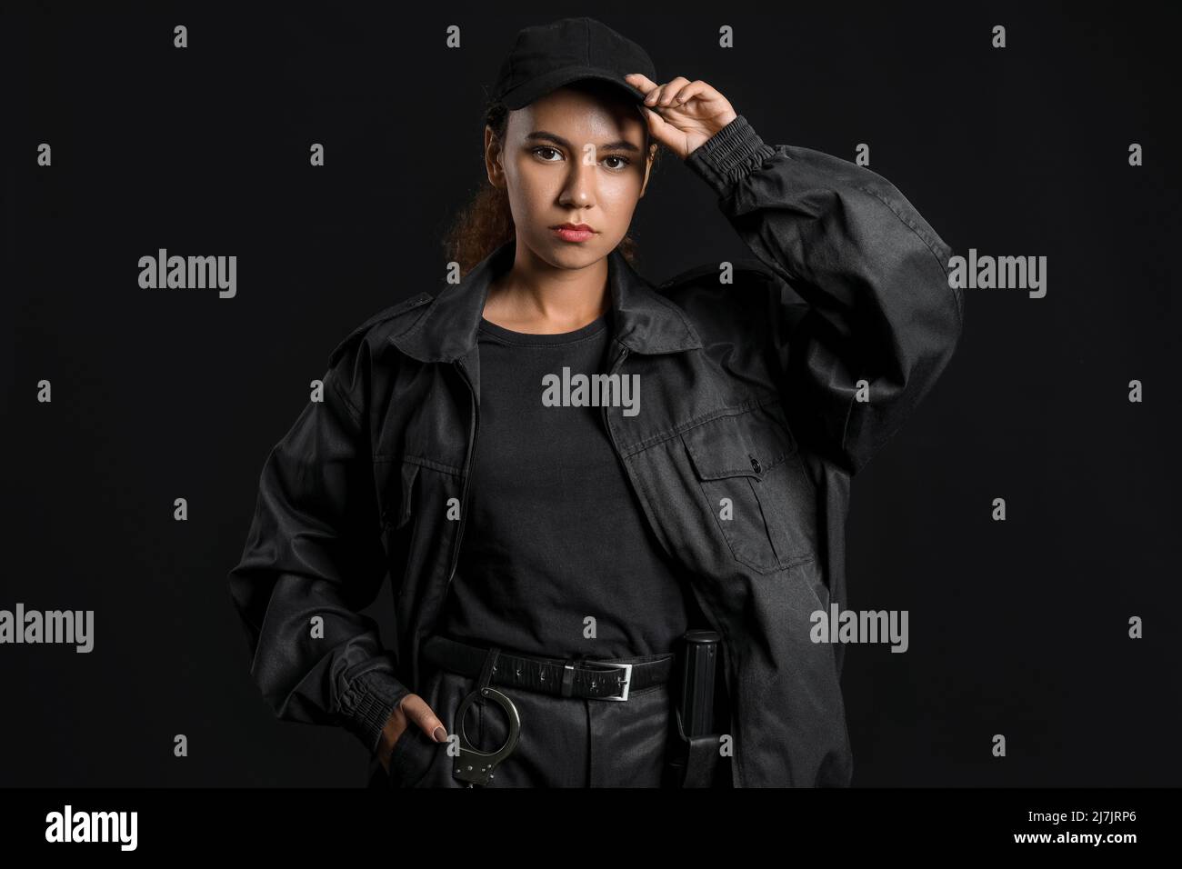 African-American female security guard on dark background Stock Photo ...