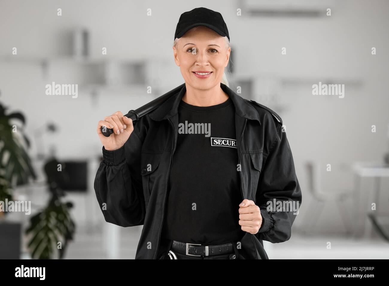 Female security guard in office Stock Photo - Alamy