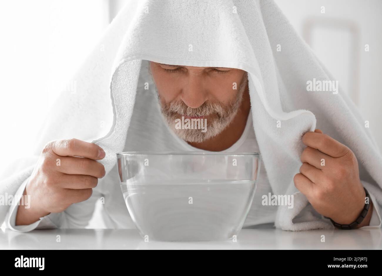 Mature man doing steam inhalation at home, closeup Stock Photo - Alamy