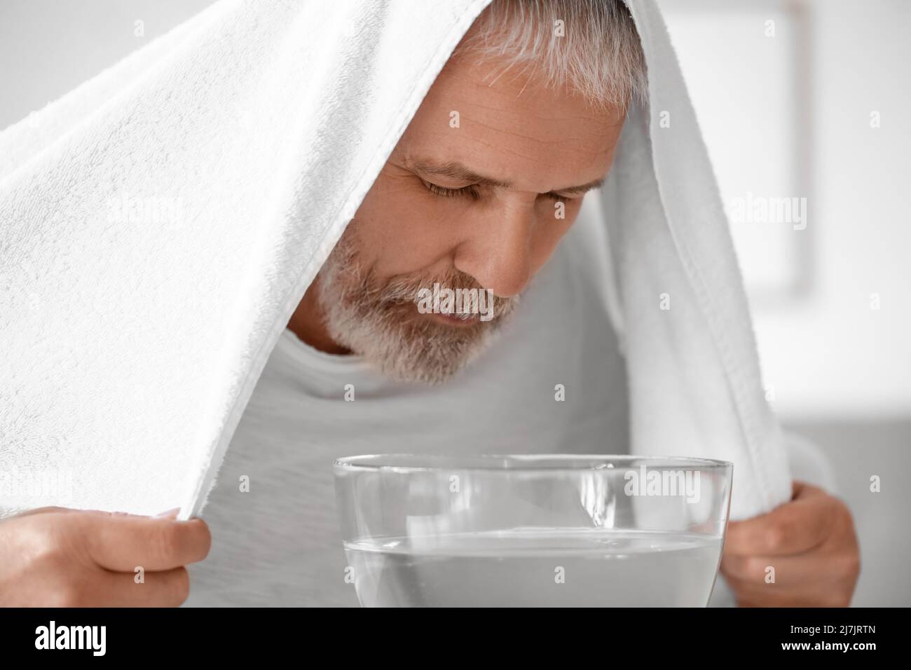 Mature man doing steam inhalation at home, closeup Stock Photo - Alamy