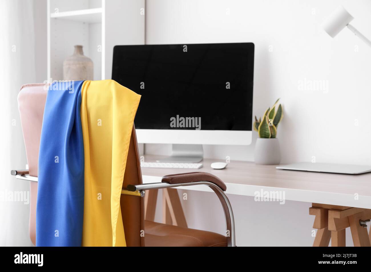 Flag of Ukraine on chair in modern office Stock Photo - Alamy