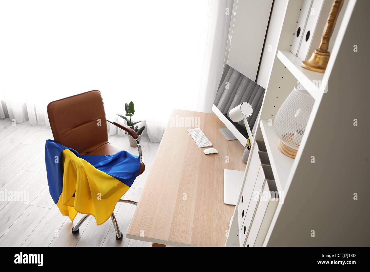 Flag of Ukraine on chair in modern office Stock Photo - Alamy