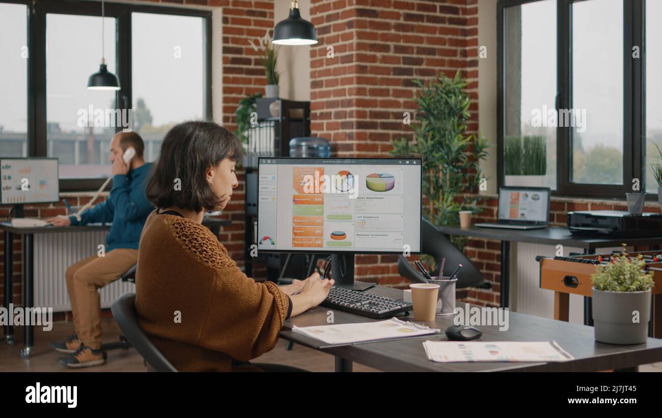 Employee working on computer to plan business project on computer at ... Employee working on computer to plan business project on computer at ...