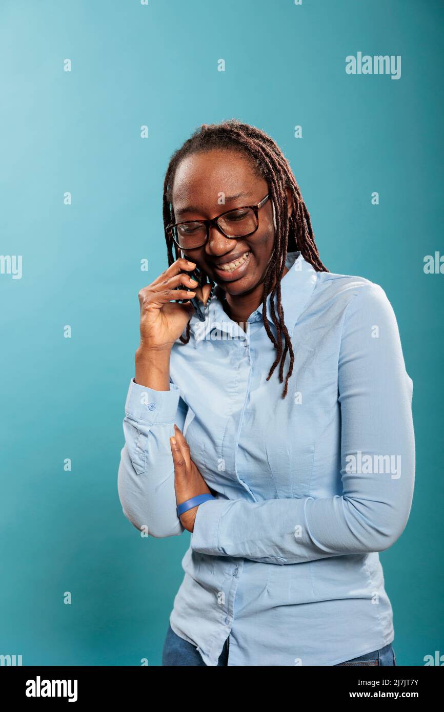 Cheerful adult person talking with friend on touchscreen cellphone ...