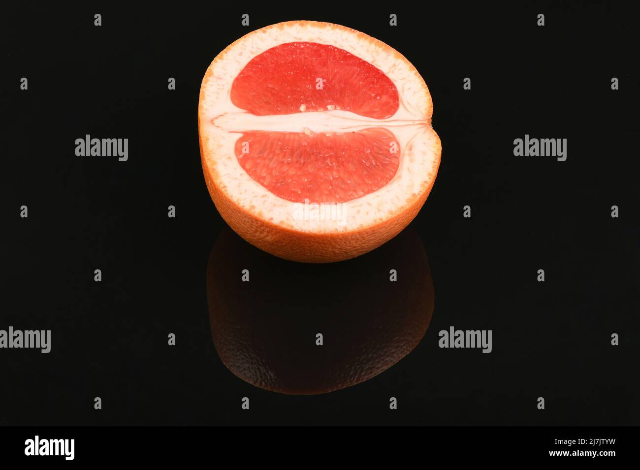 Grapefruit isolated on acrylic black background. High resolution photo ...