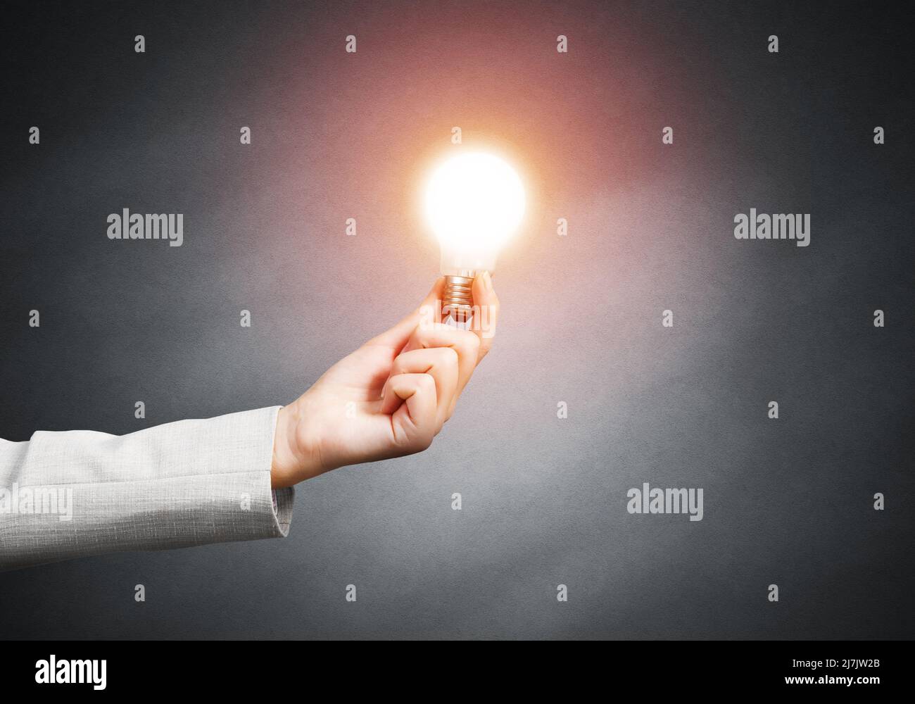 Human hand with glowing incandescent lamp Stock Photo - Alamy