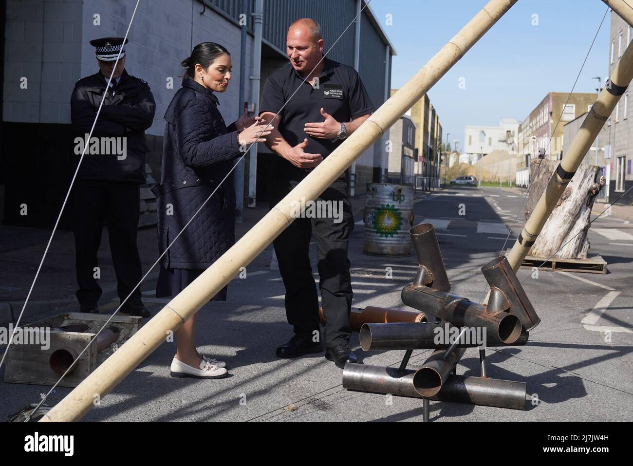Home Secretary Priti Patel is shown an item used by protesters by ...