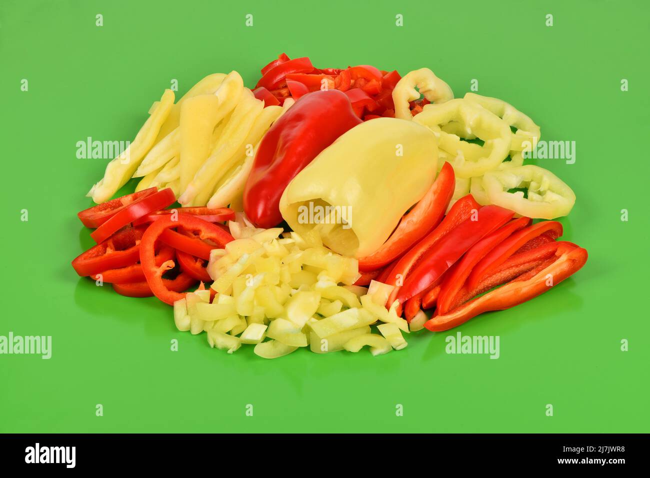 Fresh sliced paprika, Bell Pepper, isolated on green background. High ...