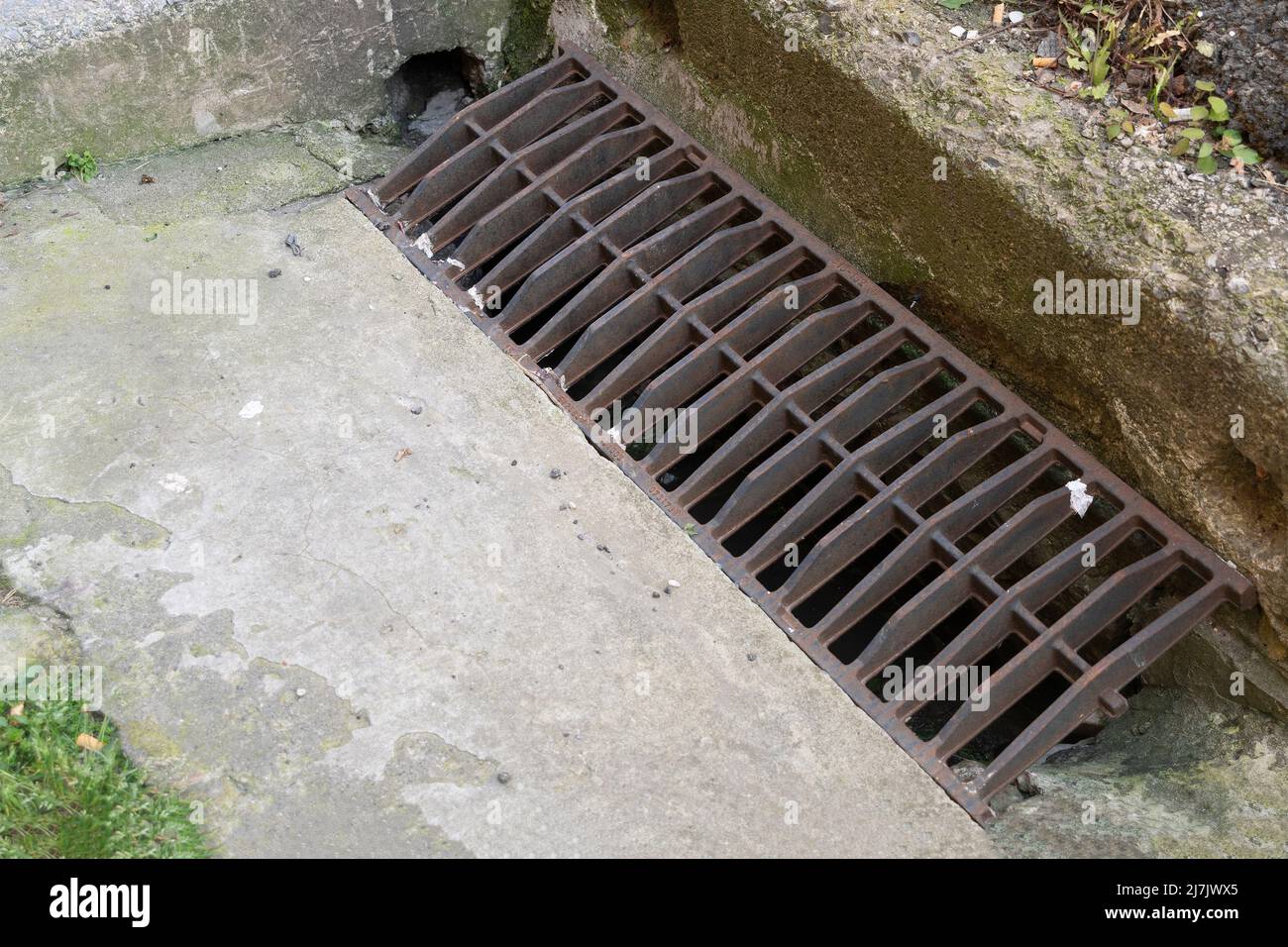 Grid for the drainage of rainwater at the edge of a road Stock Photo ...