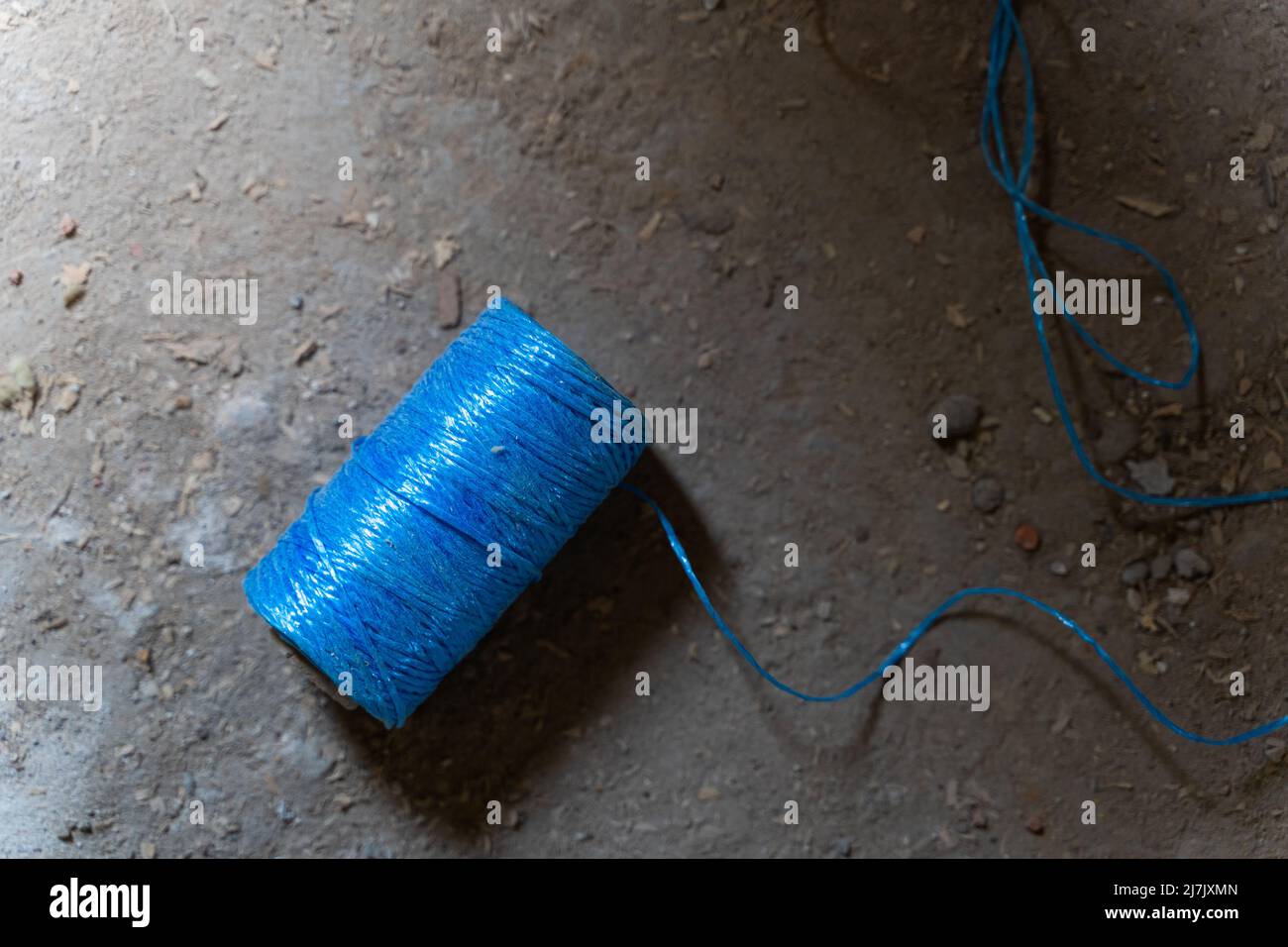 Construction polypropylene blue thread lies on the concrete floor close ...