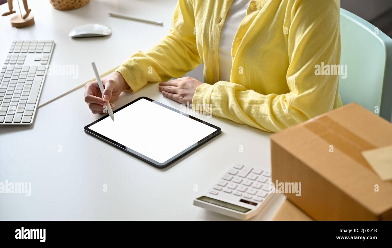 Top view, Female online seller using a tablet touchpad to check her ...