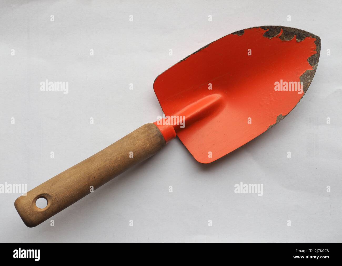 orange garden spade over an off-white background Stock Photo - Alamy