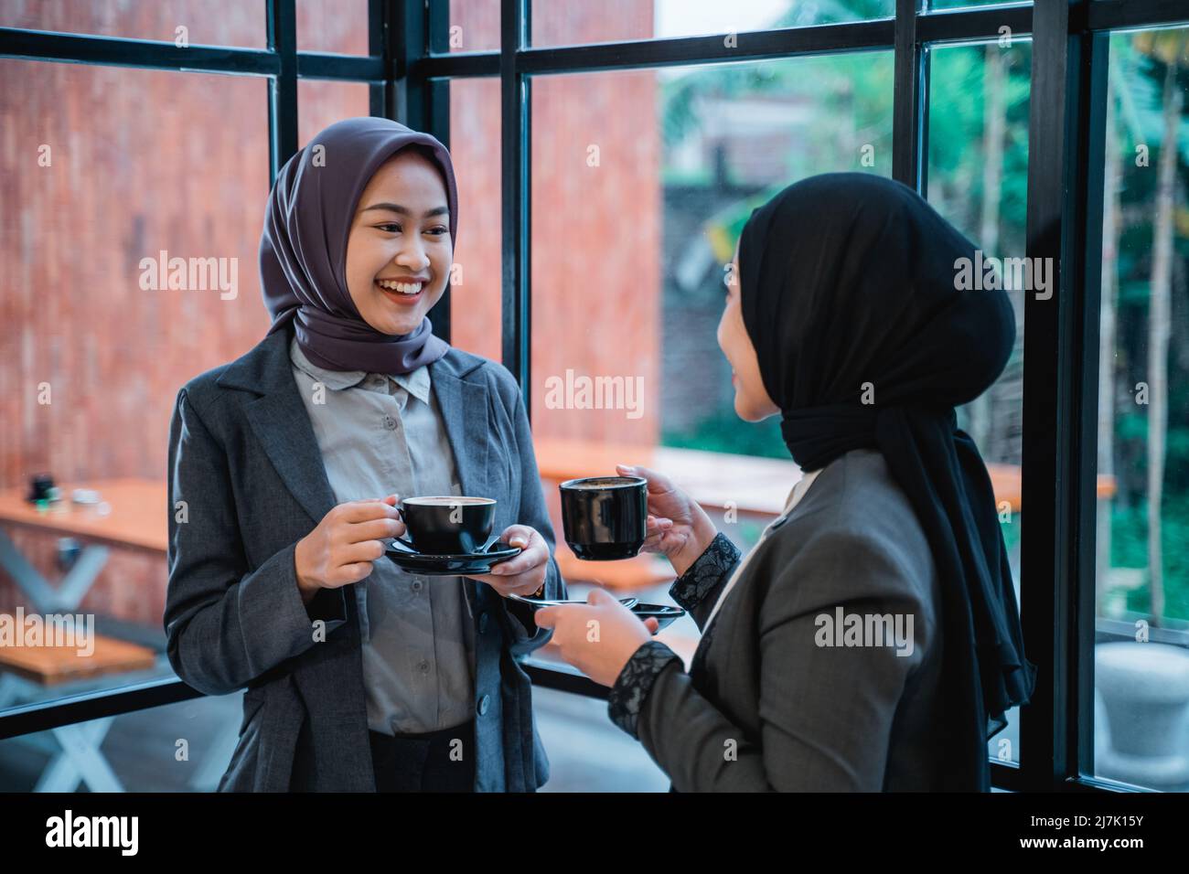 muslim business woman wearing hijab having a conversation together ...