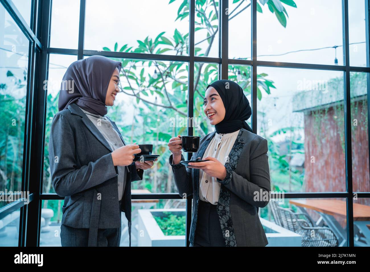 muslim business woman wearing hijab having a conversation together ...