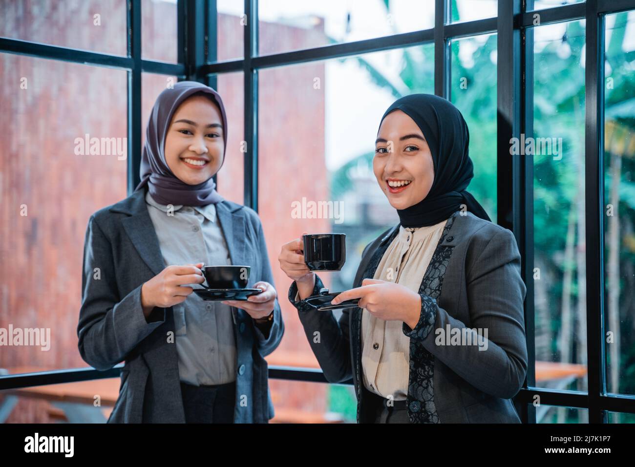 muslim business woman wearing hijab having a conversation together ...
