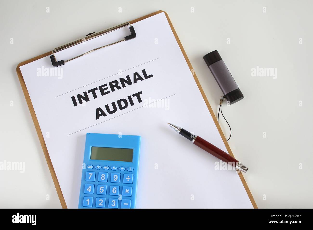 Audit word on working paper with pen, measuring tape and calculator ...