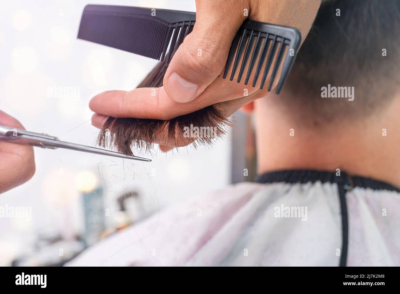 Trimming the ends of the hair with scissors in the barbershop Stock ...