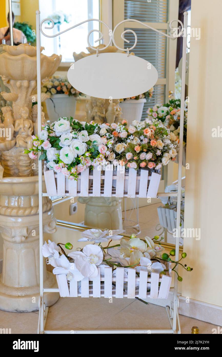 stand with flowers and a white sign for the inscription in a flower ...