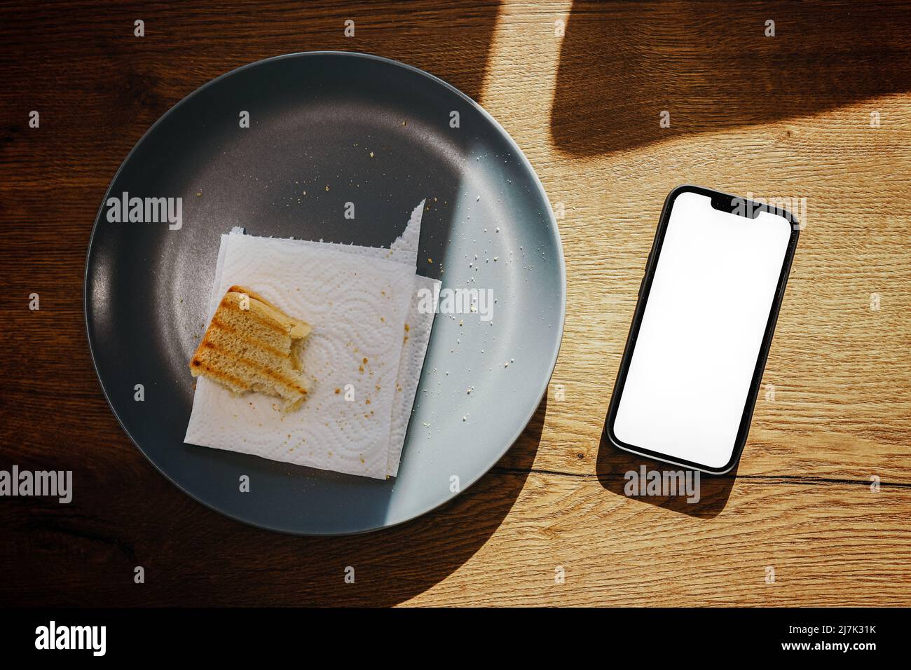 Smartphone and toasted bread on the plate in kitchen, top view Stock ...